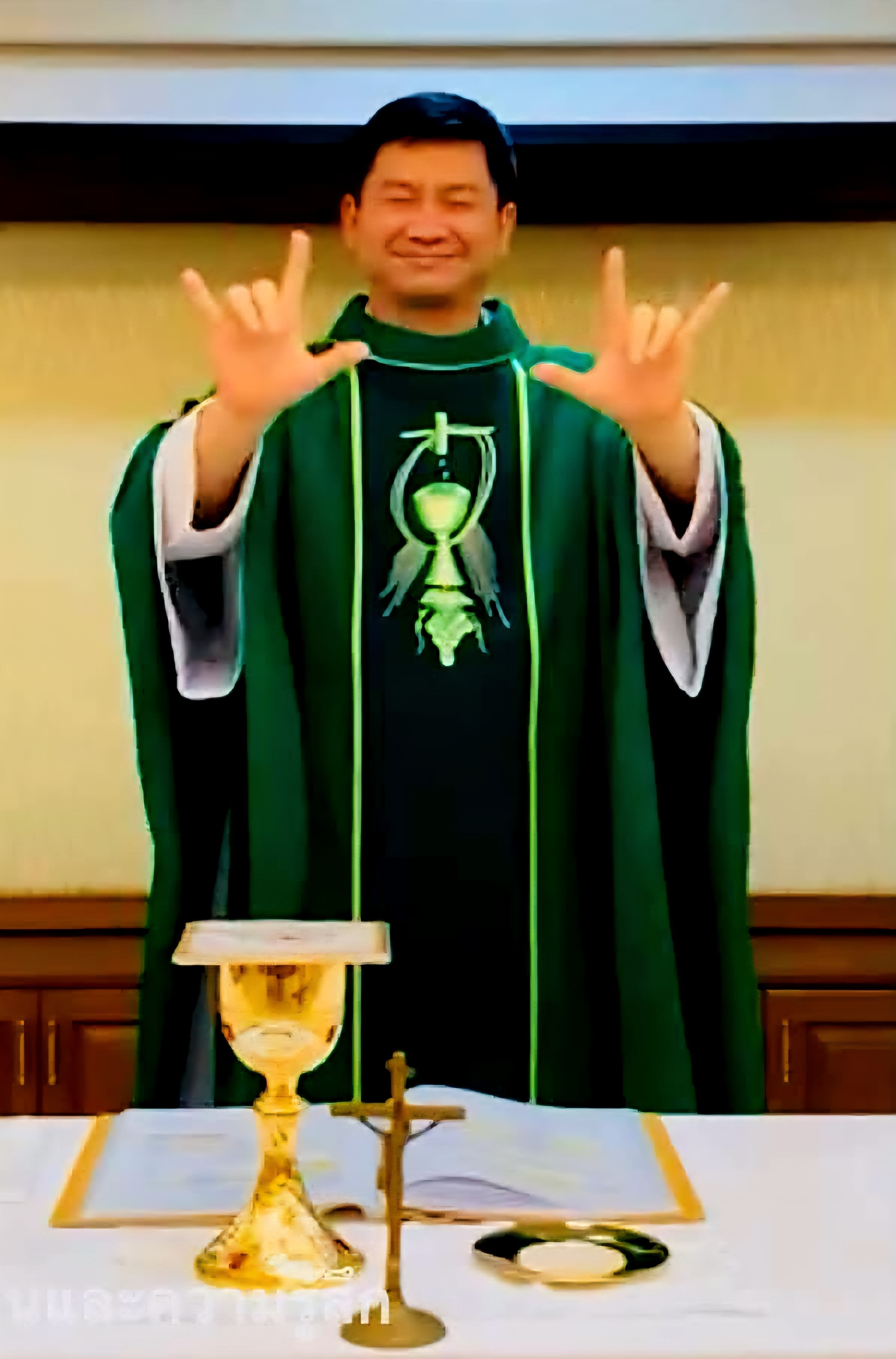A Catholic priest from Thailand using sign language while celebrating Mass